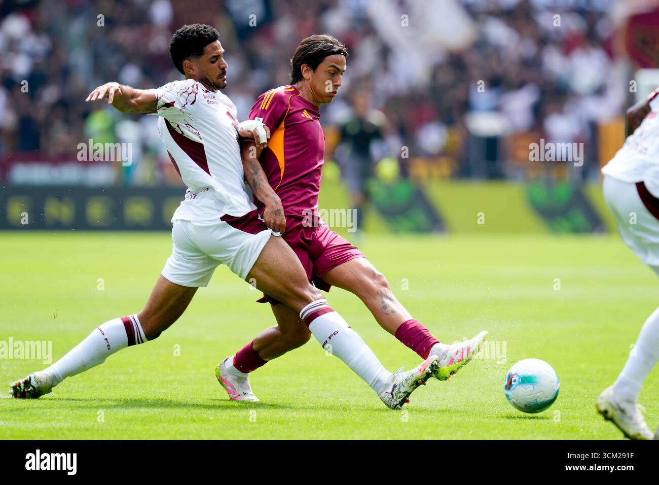 Saul Coco of Torino FC and Paulo Dybala of AS Roma compete for the ball ...