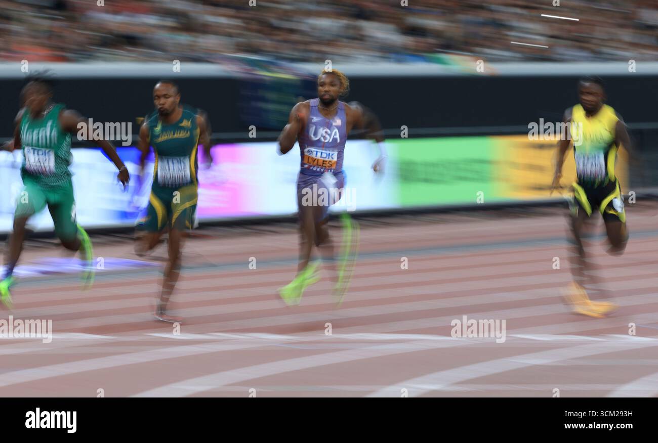 Athletes compete in the women's 100 meters semi-final at the World ...