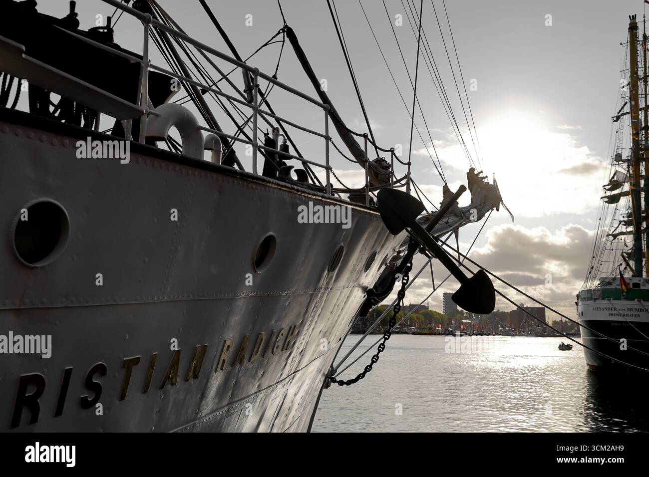 Sunlit bow of a tall sailing ship with anchor chain and figurehead ...