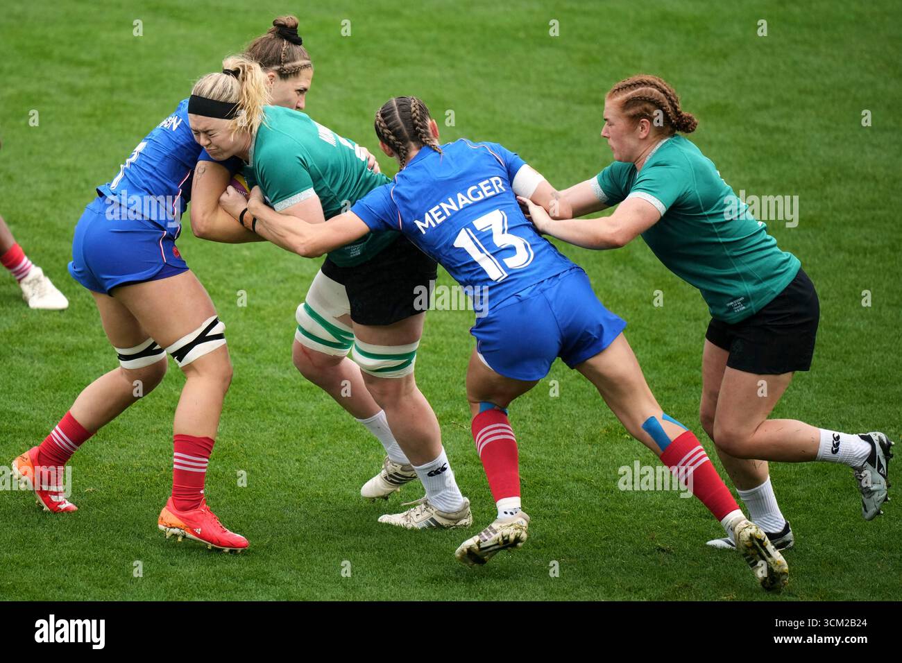 Ireland's captain Sam Monaghan, center, is tackled by France's Lea ...