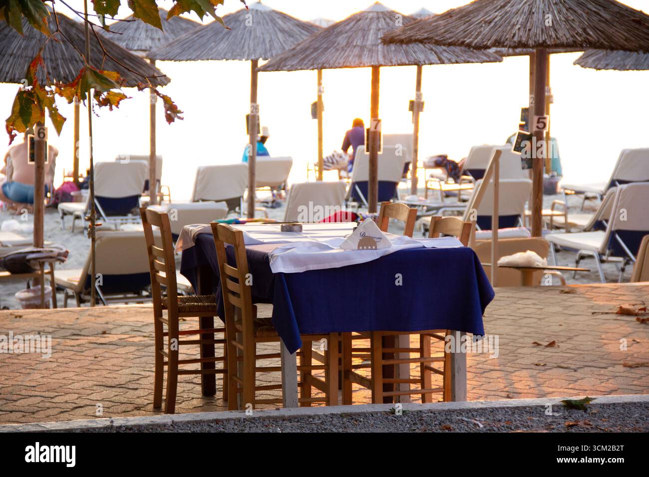 table and blue chairs in a seaside tavern Stock Photo - Alamy