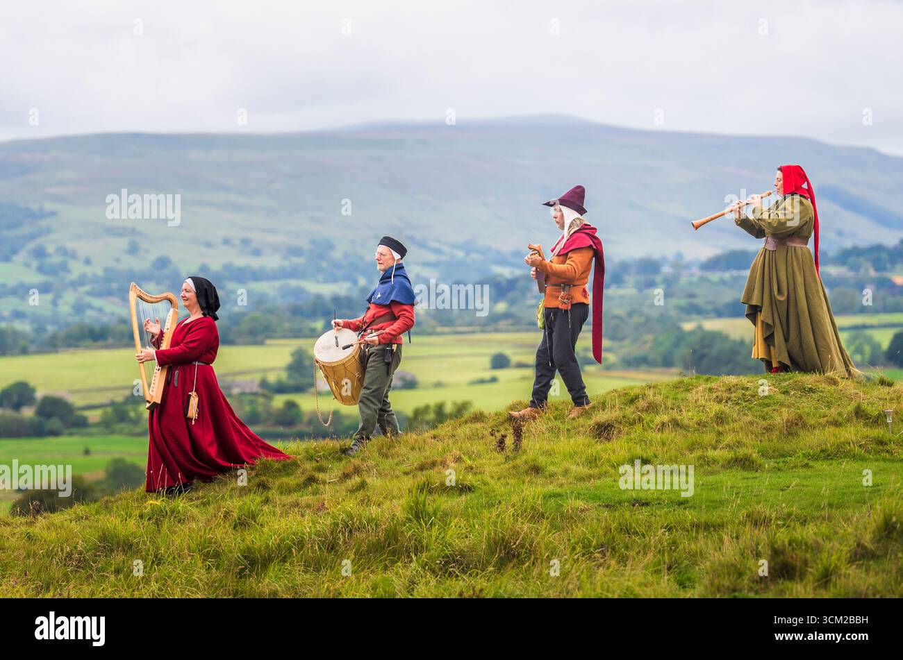 Left to right, musicians wearing traditional 15th century clothing ...