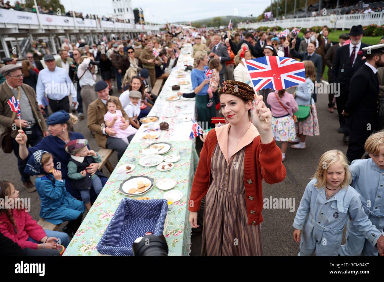 Racemeet goers take part in a VE Day 80th-anniversary street party on ...