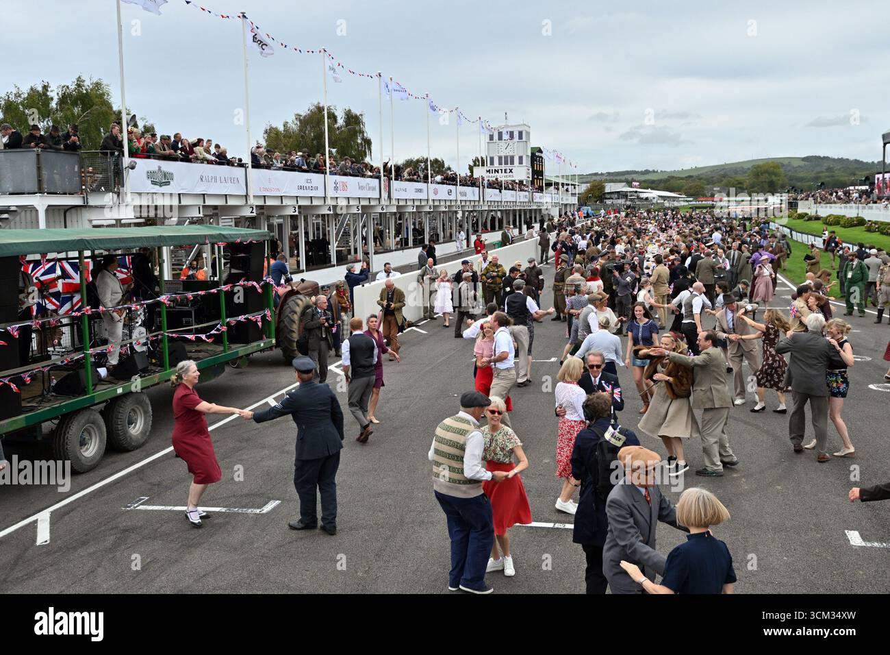 Racemeet goers take part in a VE Day 80th-anniversary street party at ...