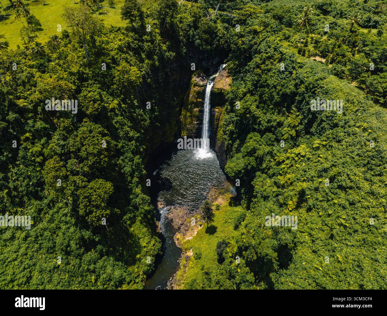 Aerial view of the Fuipisia Waterfall cascading into a dark pool ...