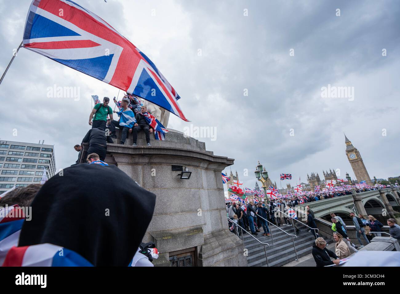 Patriots cross Westminster bridge holding aloft Union Jack flags during ...