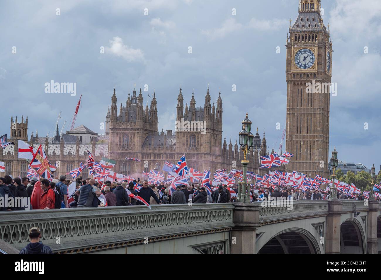 Patriots cross Westminster bridge holding aloft Union Jack flags during ...