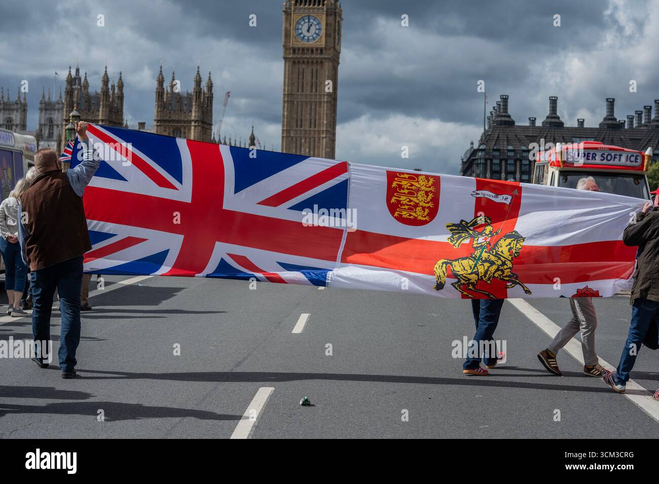 Patriots hold aloft a huge Union Jack flag as they approach Westminster ...
