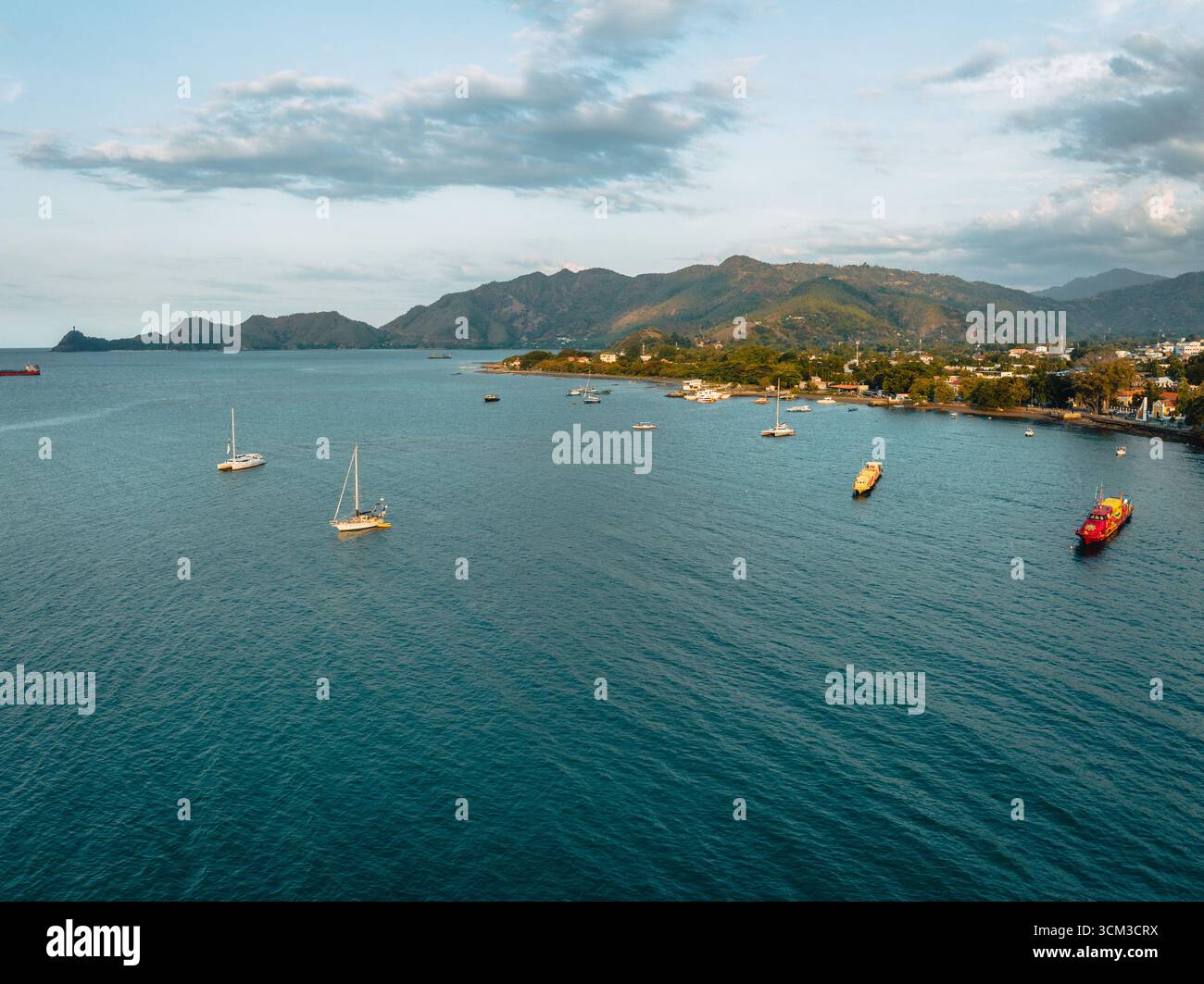 Aerial view of boats bobbing on azure waters near the coast, a ...