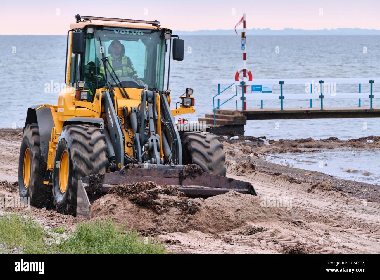 Helsingborg, Sweden ; August 12, 2025: Volvo wheel loader pushing ...