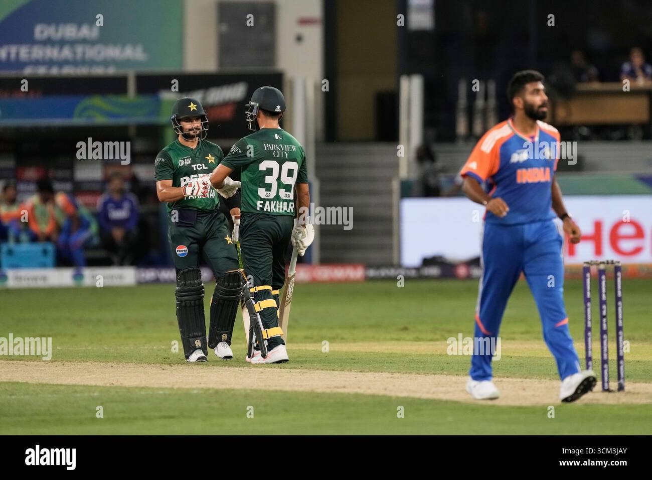 Pakistan's Sahibzada Farhan, left, celebrates scoring runs with batting ...