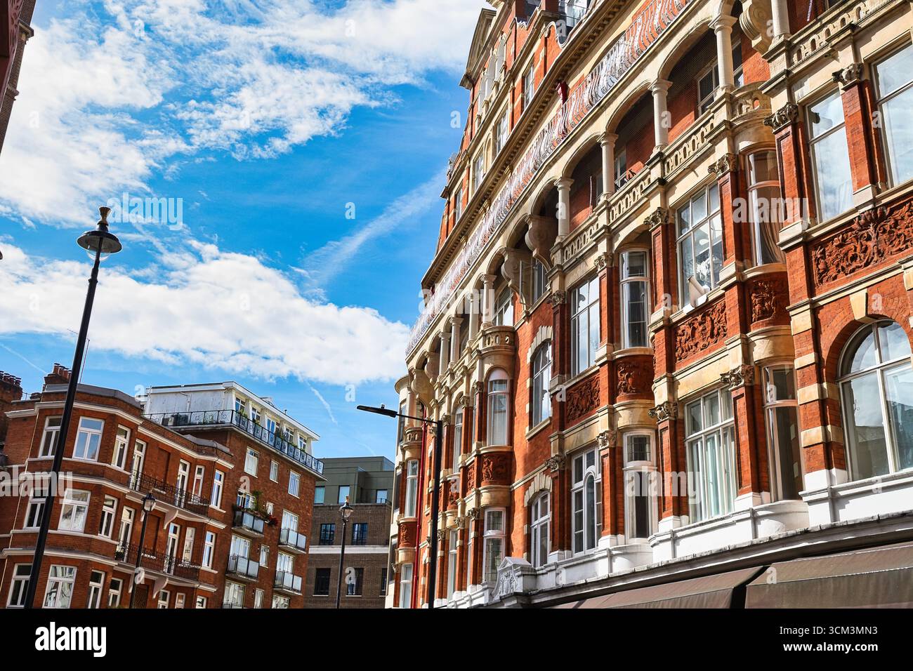 An ornate red brick building with arched windows and decorative ...