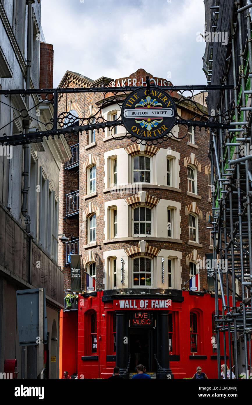 A multi-story brick building with a red ground floor, a prominent sign ...