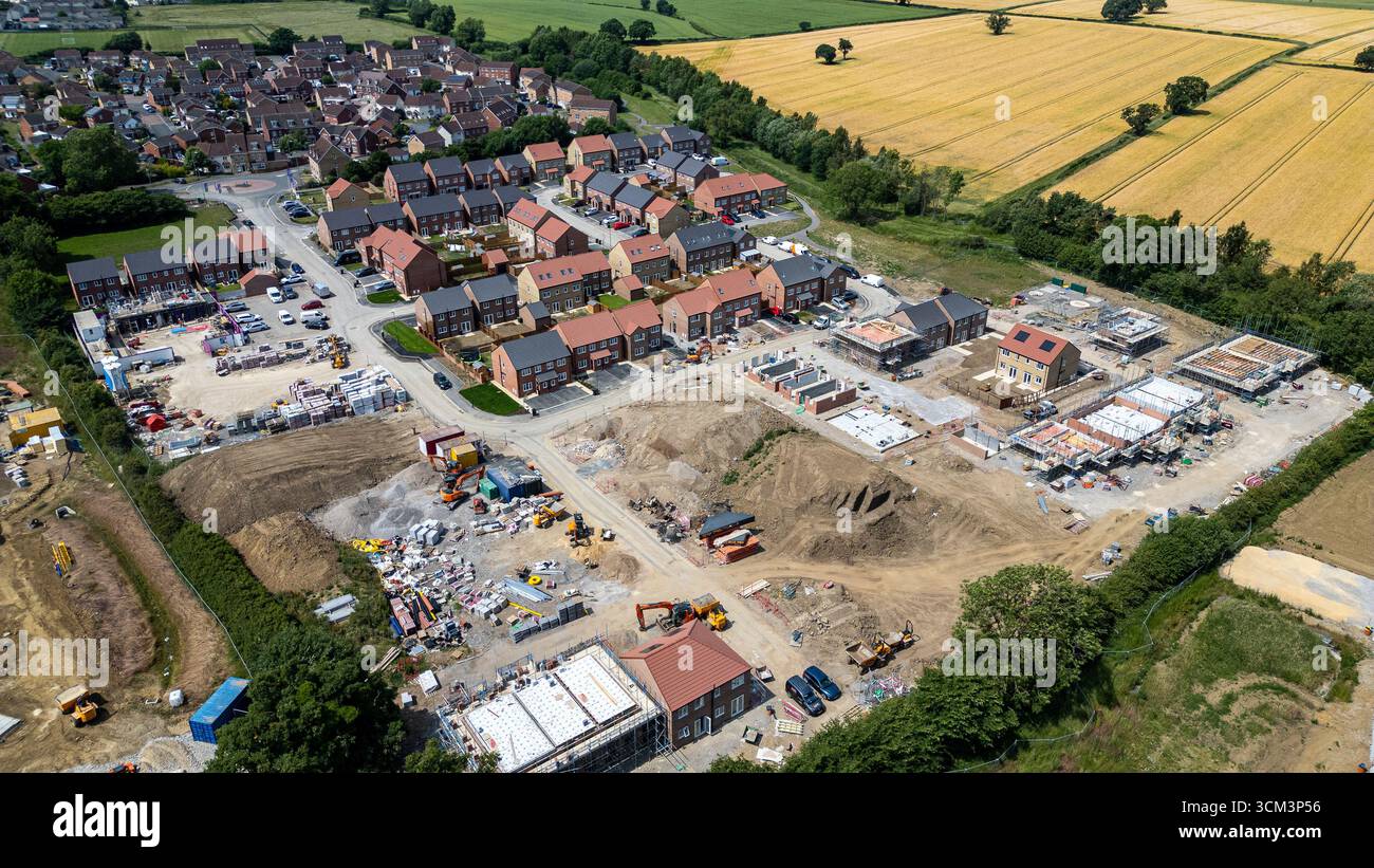 Aerial view of a residential construction site adjacent to a completed ...