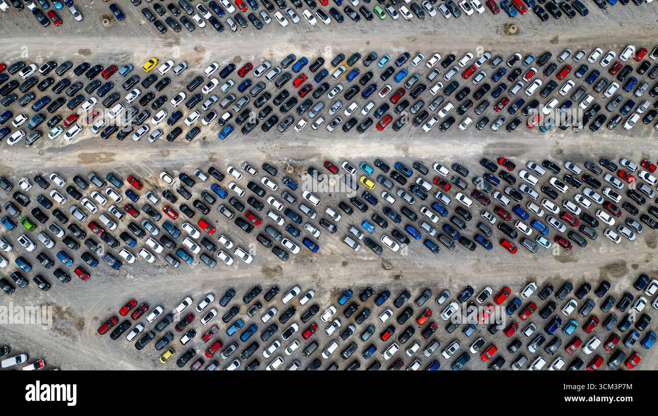 Aerial view of a vast, organized lot filled with rows of parked cars of ...