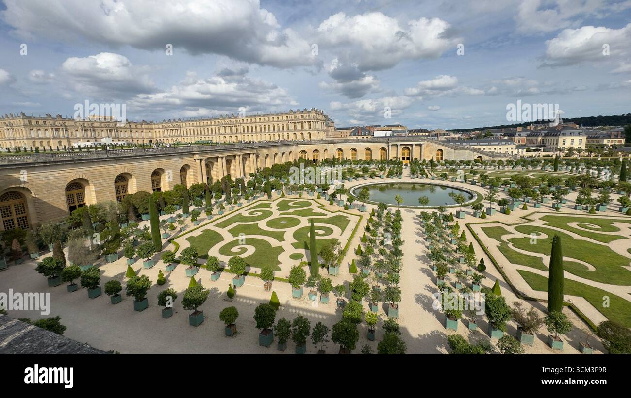 An aerial view captures the expansive Gardens of Versailles, featuring ...