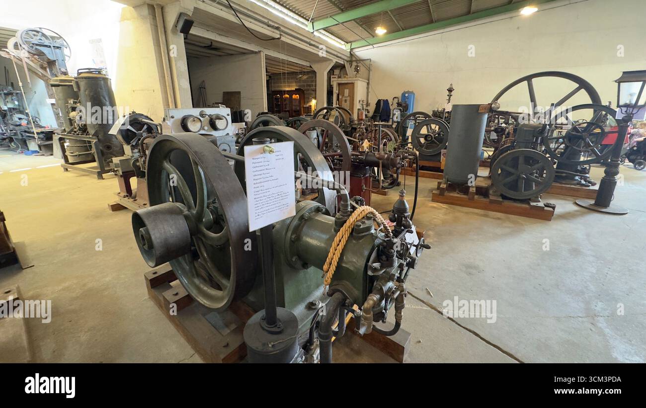A museum display of vintage machinery, primarily large, dark-colored ...
