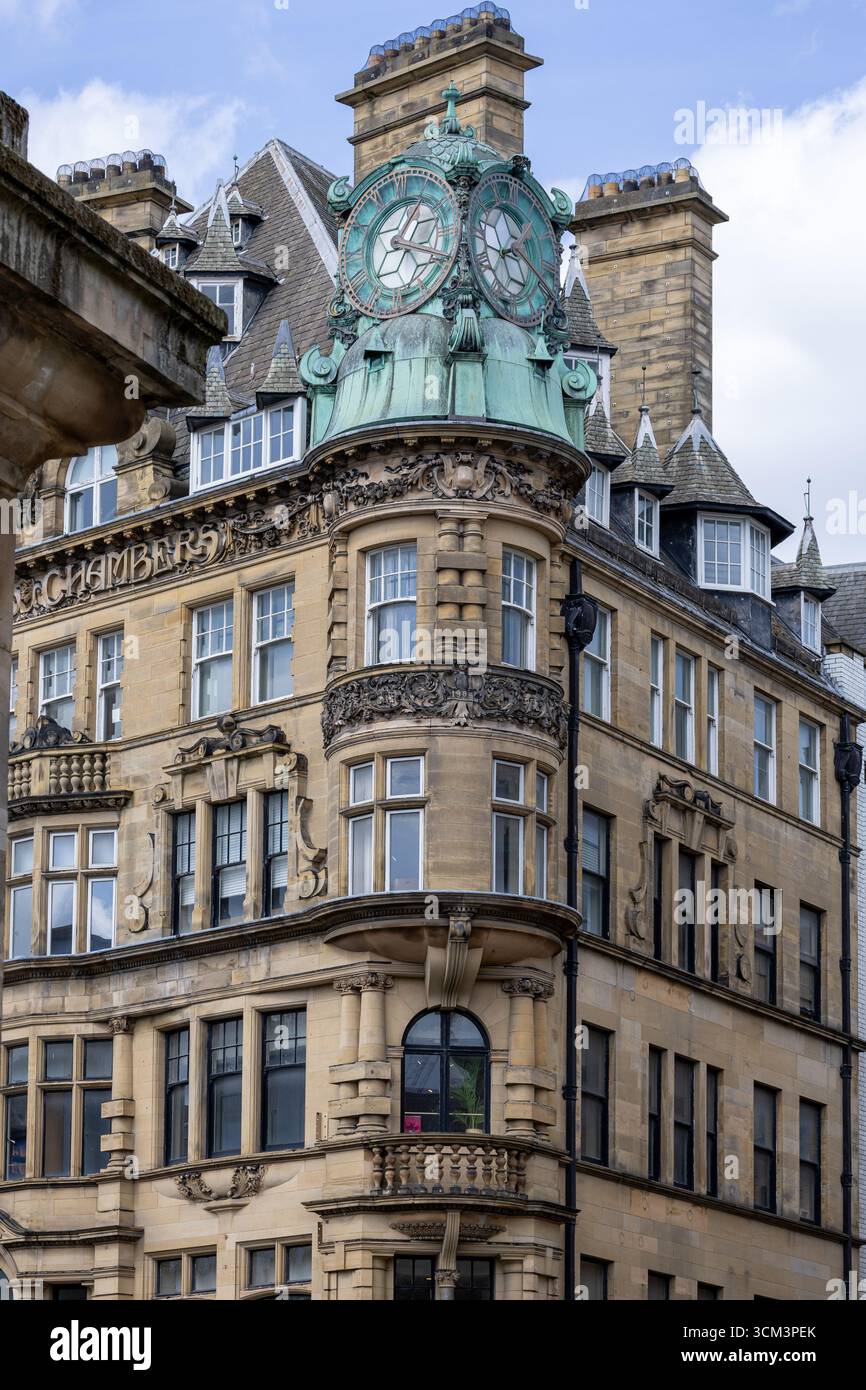 A detailed view of an ornate sandstone building featuring a prominent ...