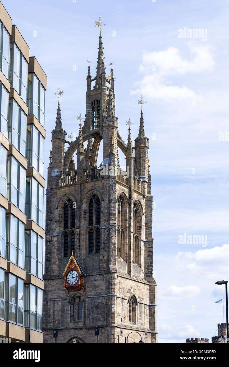 A tall, gothic stone church tower with multiple spires and ornate ...