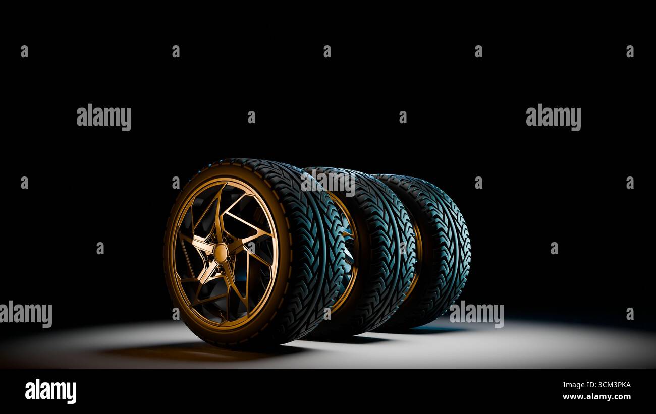 Three black car tires with detailed tread patterns mounted on a golden ...