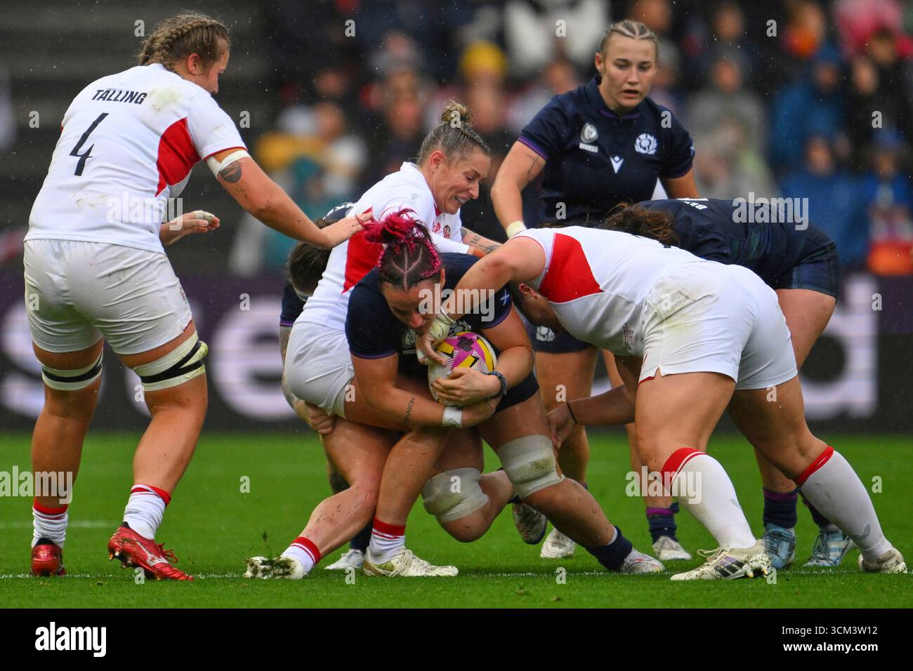 Evie Gallagher of Scotland, center, is tackled during the Women's Rugby ...