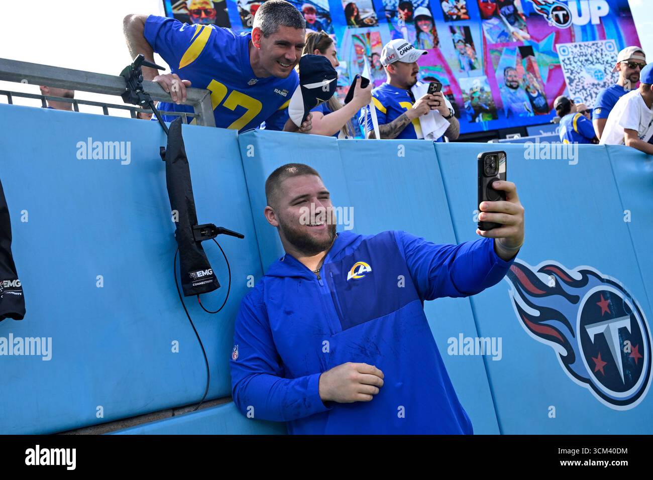 Los Angeles Rams defensive end Braden Fiske takes a picture with a fan ...