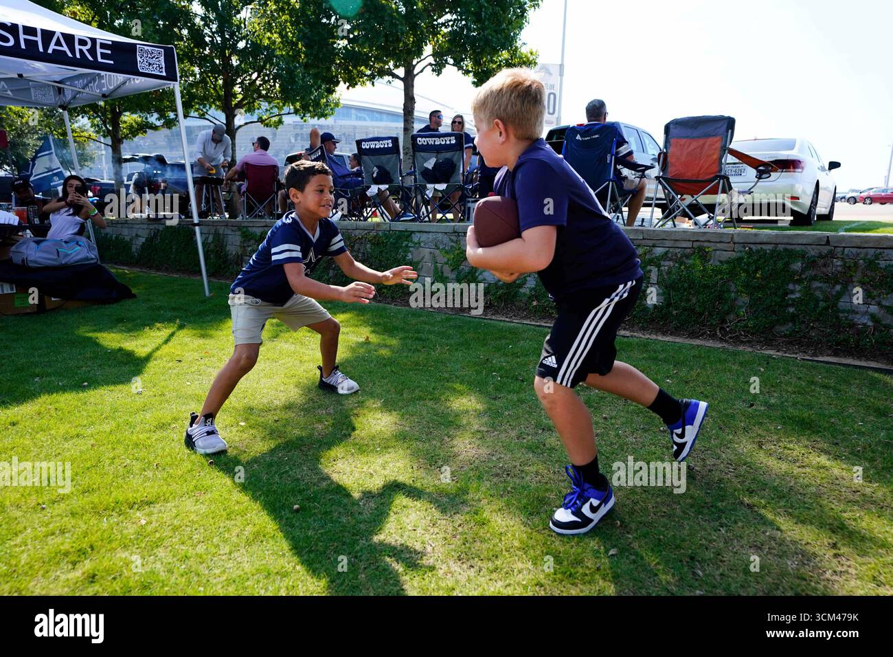 Lawson Barton, left, and Hudson Fry, right, play as their familes ...
