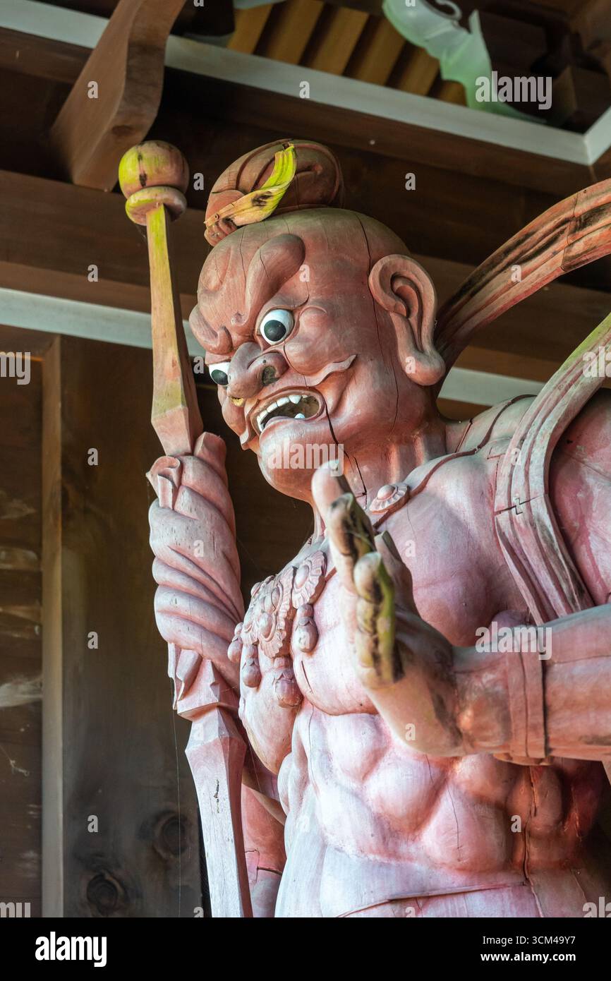 A fierce Nio guardian statue stands at the entrance of Misen Niomon ...