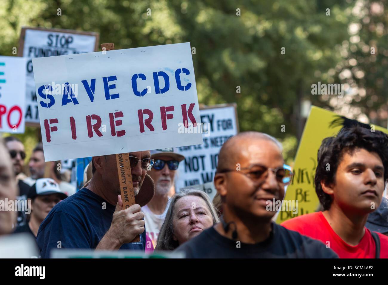 Atlanta, GA / USA - September 1, 2025: Man holds sign reading "Save CDC ...