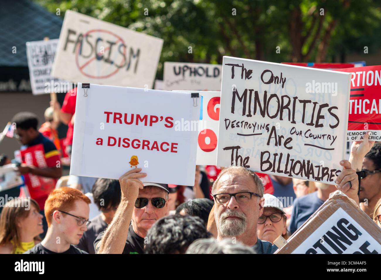 Atlanta, GA / USA - September 1, 2025: People hold various signs at the ...