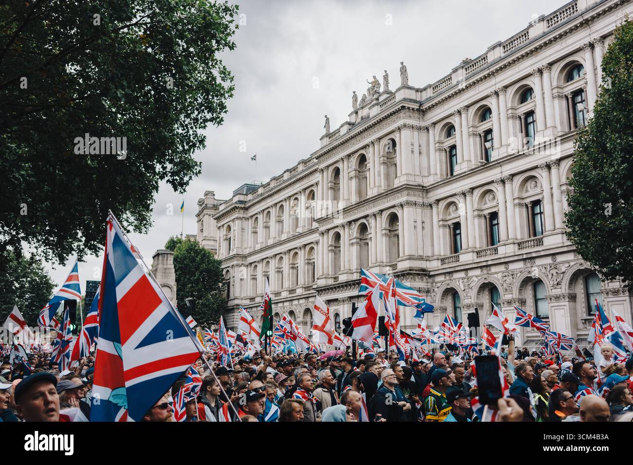 London, UK – 2025.09.13 – A large crowd waves Union Jack and St. George ...