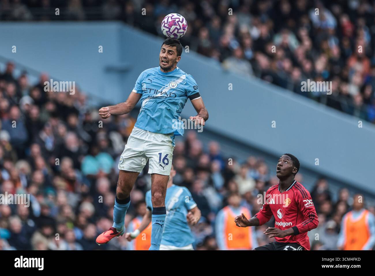 Rodrigo of Manchester City jumps up to win the high ball during the ...