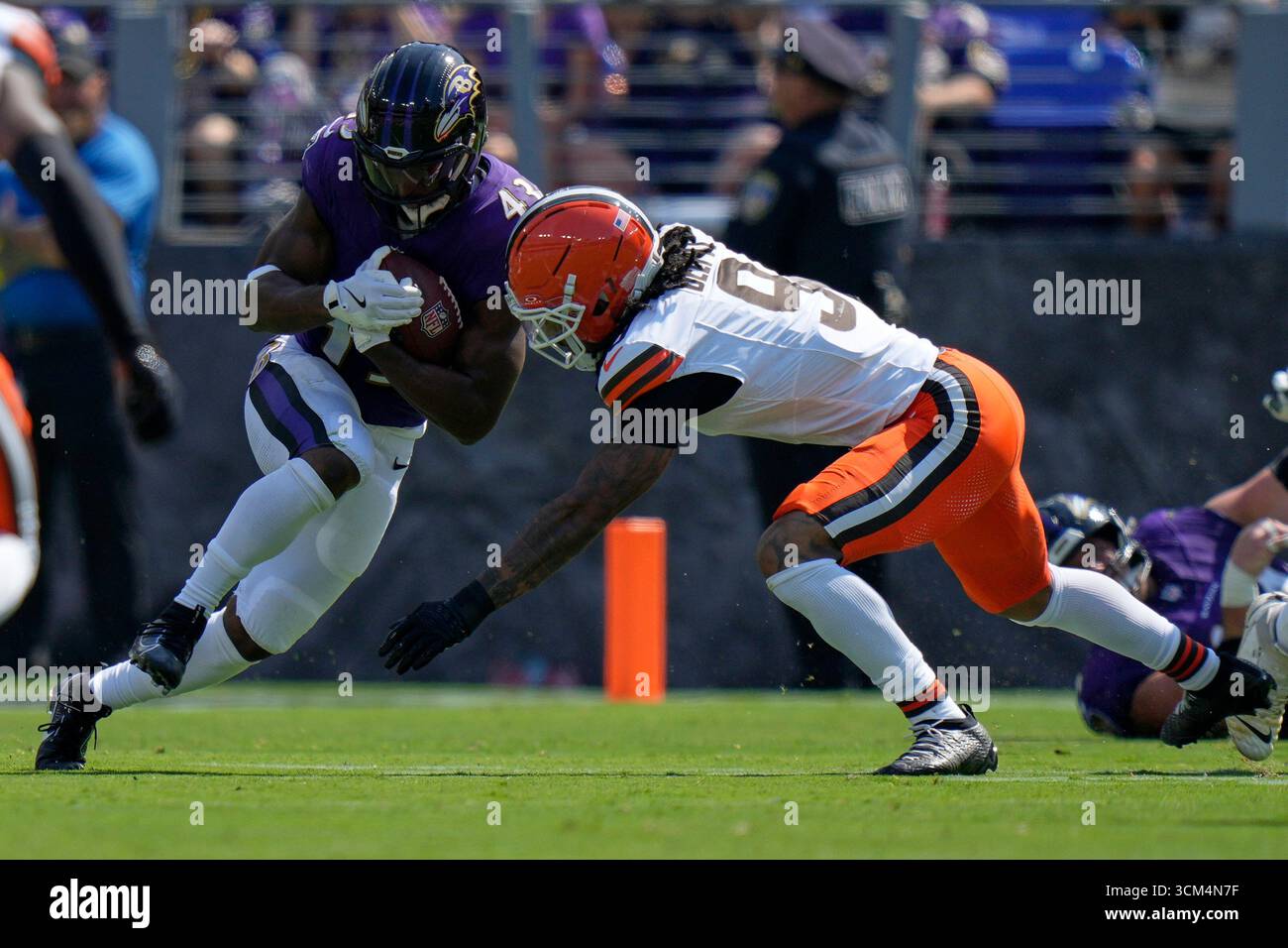 Baltimore Ravens running back Justice Hill is tackled by Cleveland ...