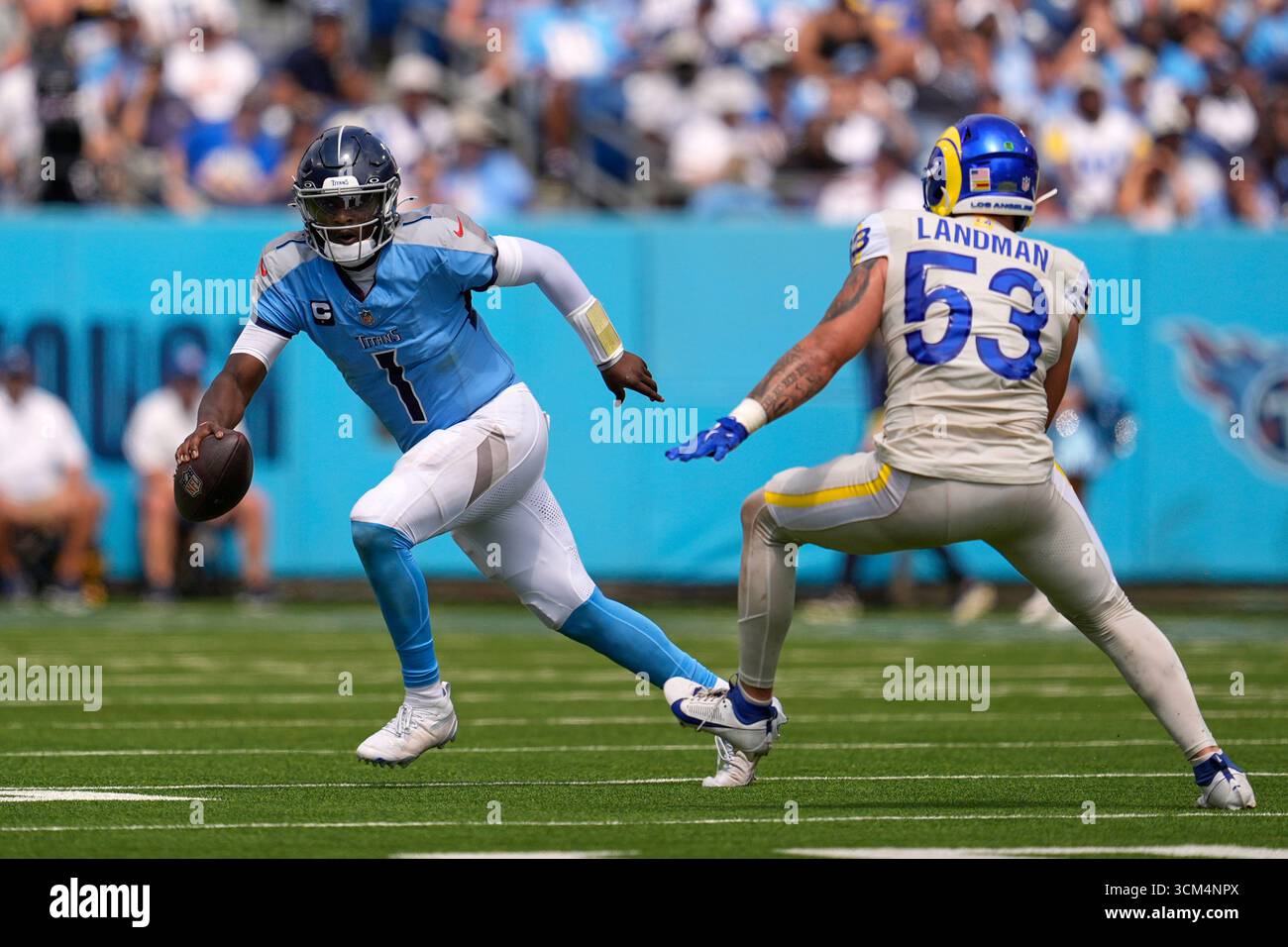 Tennessee Titans quarterback Cam Ward, left, runs for a first down as ...