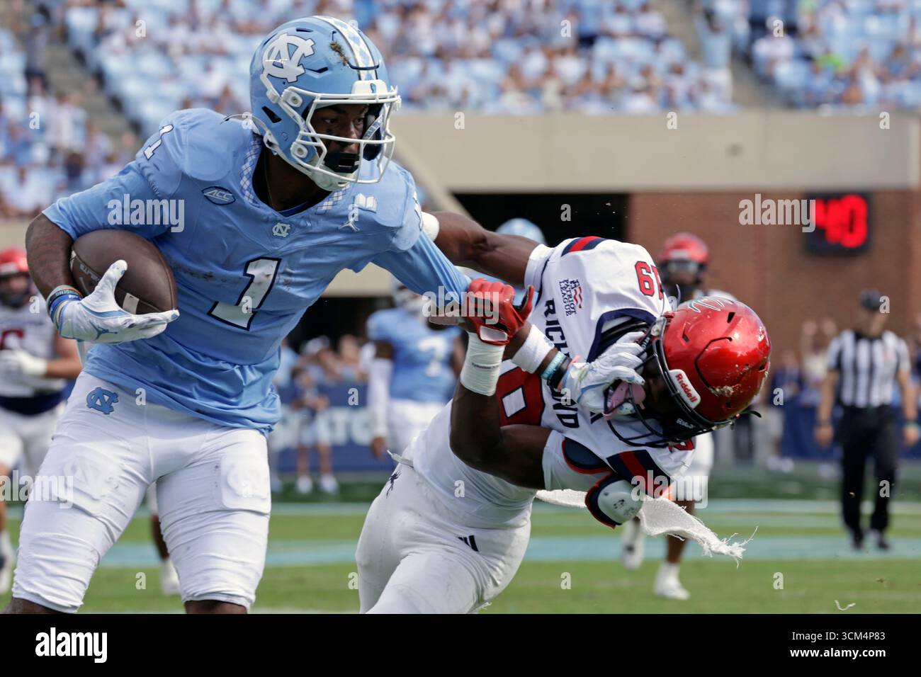 North Carolina wide receiver Jordan Shipp (1) stiff-arms Richmond ...