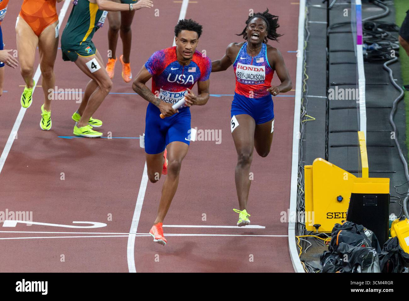 Lynna Irby-Jackson (USA) hands the baton off to Jenoah McKiver (USA) as ...