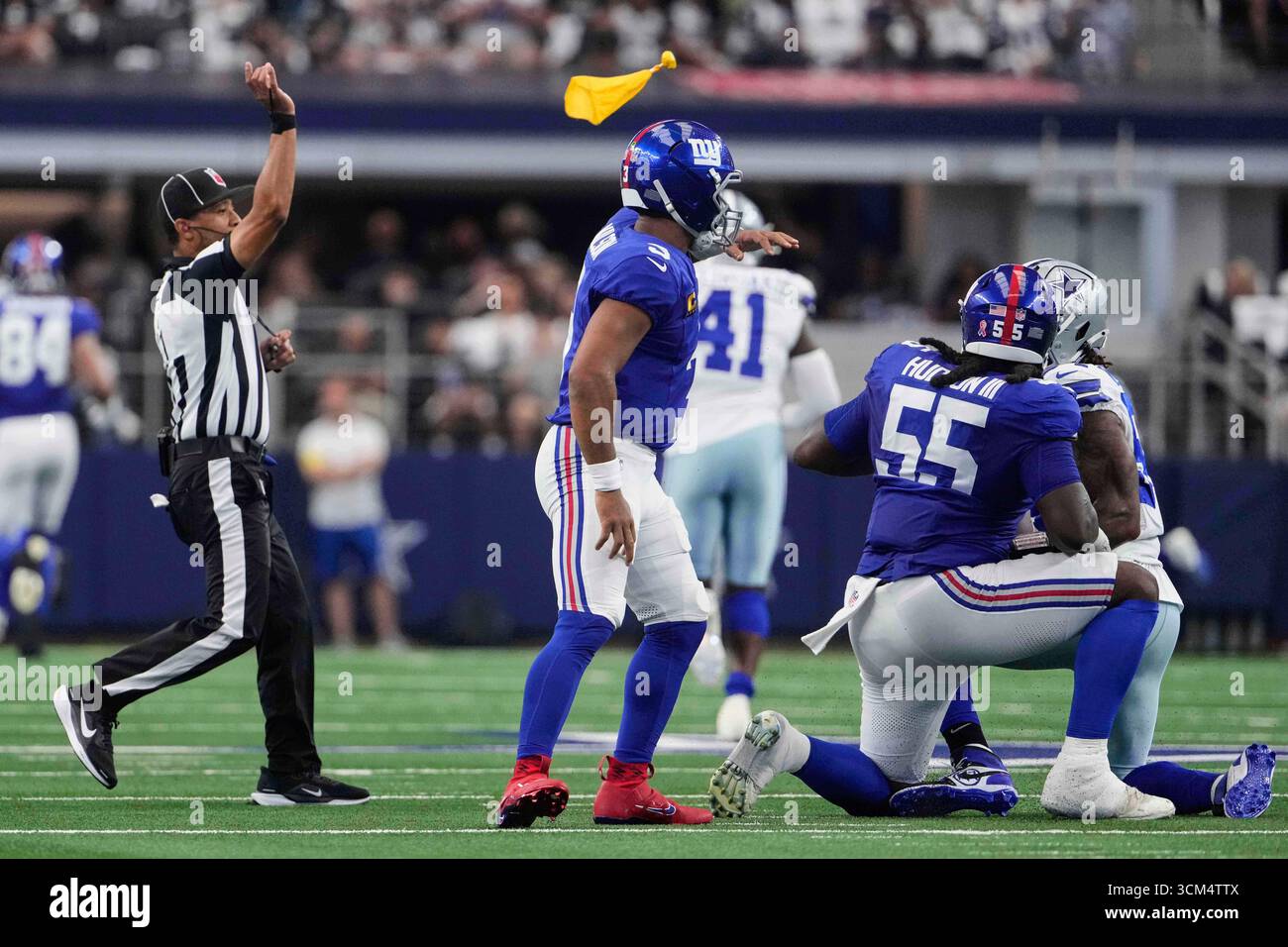 An official throws a penalty flag after a play that involved New York ...