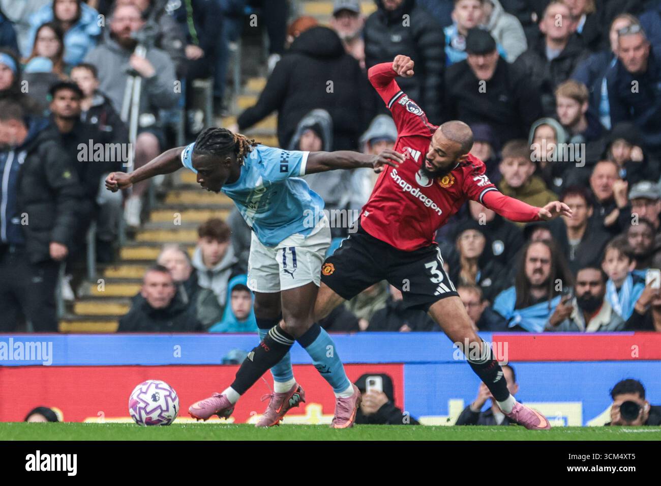 Jeremy Doku of Manchester City and Noussair Mazraoui of Manchester ...