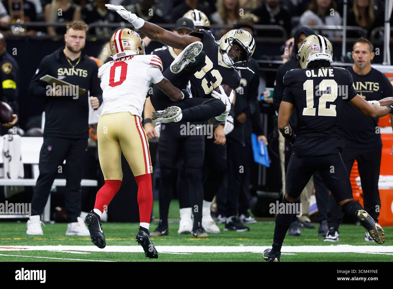 New Orleans Saints tight end Juwan Johnson, middle, is tackled by San Francisco 49ers cornerback ...