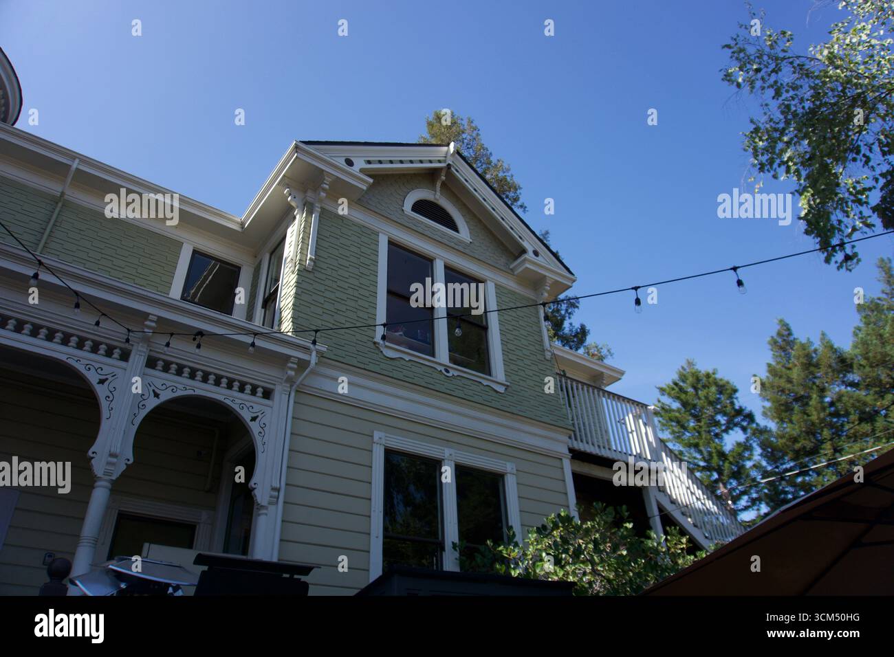 Victorian-style house facade with ornate trim and balcony Stock Photo ...