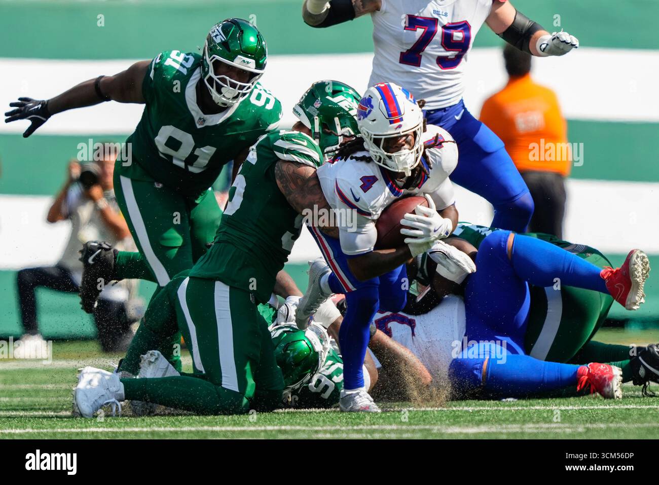 Buffalo Bills running back James Cook (4) is tackled by New York Jets ...