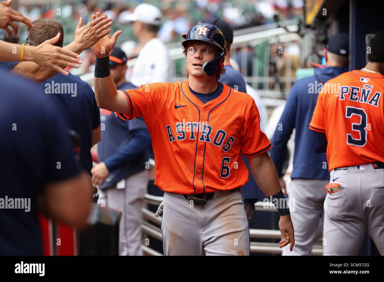 Houston Astros' Jake Meyers (6) high-fives teammates in the dugout ...