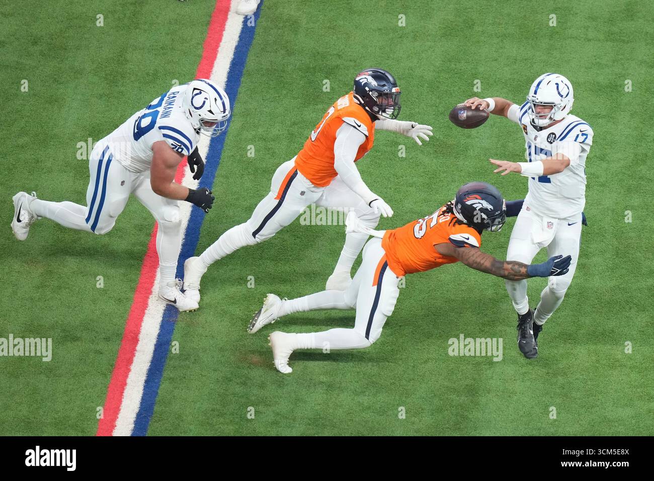 Indianapolis Colts quarterback Daniel Jones (17) is hit by Denver ...