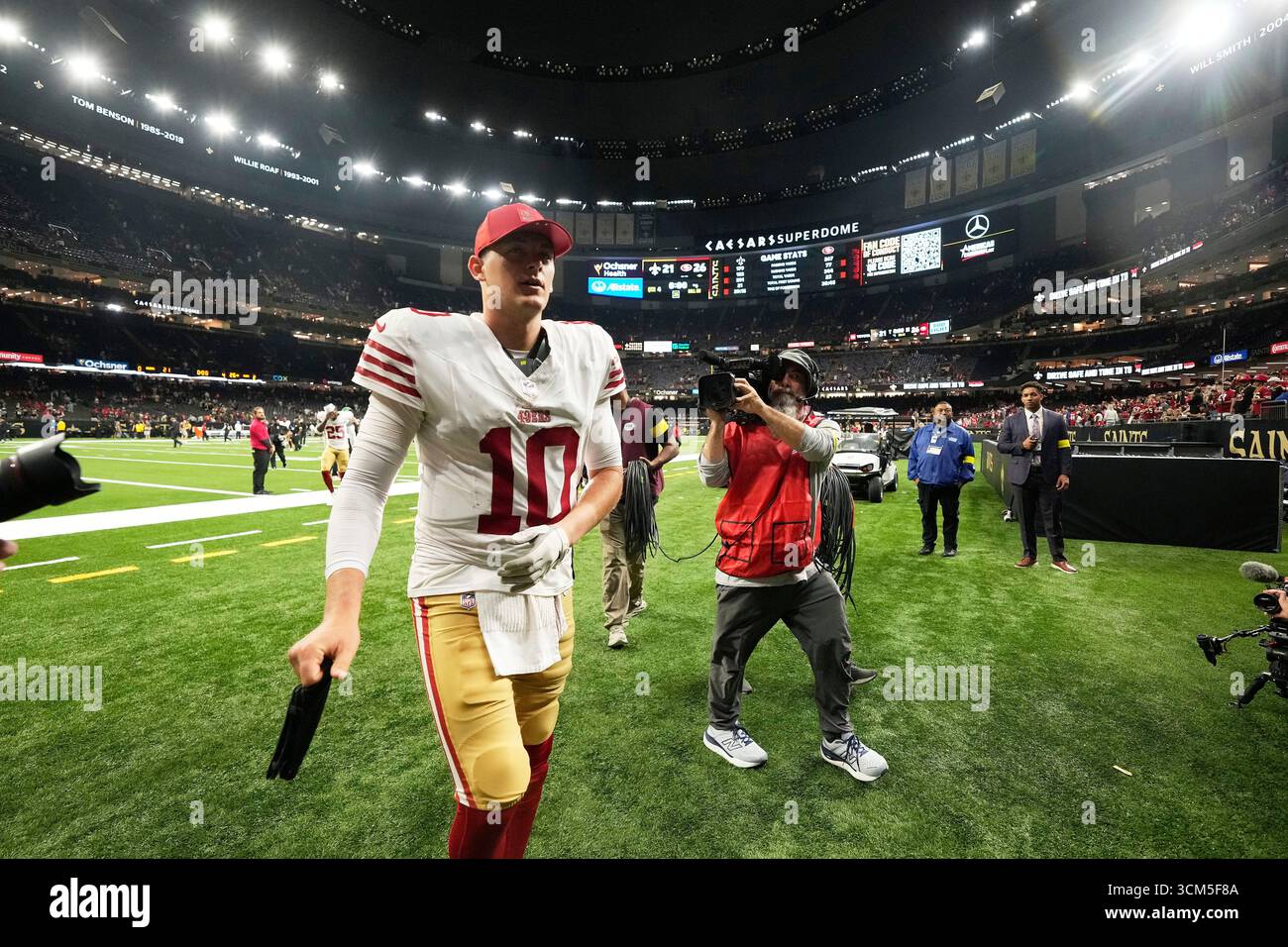 San Francisco 49ers quarterback Mac Jones (10) walks off the field ...