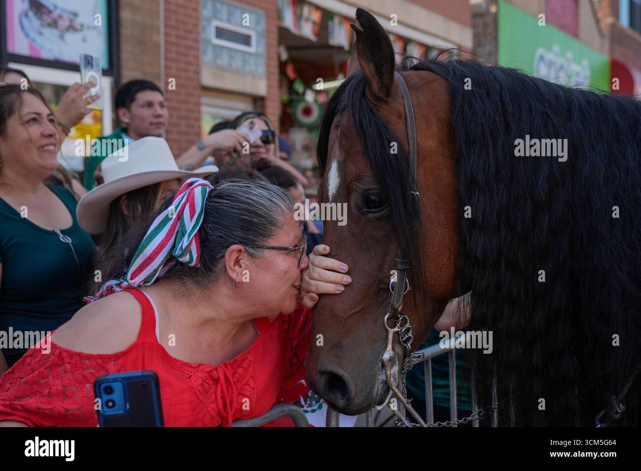 Sonya Contreras pets a horse during the Mexican Independence Day Parade ...