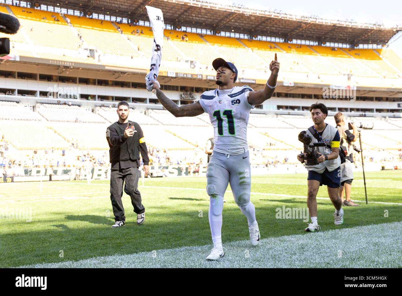 Seattle Seahawks wide receiver Jaxon Smith-Njigba (11) exits the field after an NFL football ...