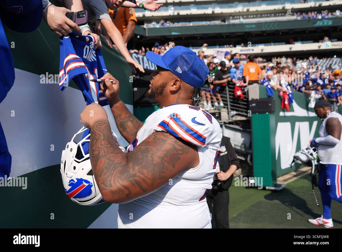 Buffalo Bills offensive tackle Dion Dawkins (73) signs autographs after ...
