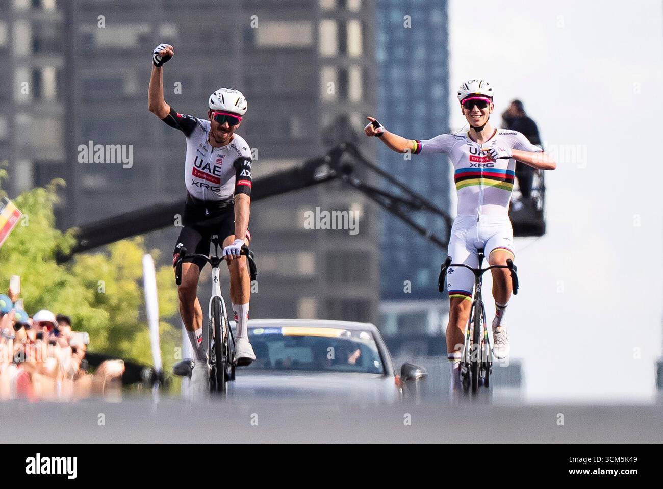 Brandon McNulty from the USA, left, finishes first ahead of Tadej ...