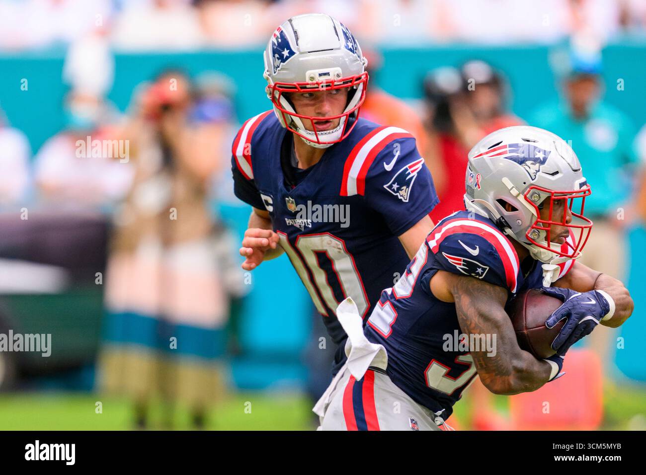 New Englands Patriots quarterback Drake Maye (10) hands off the ball to ...