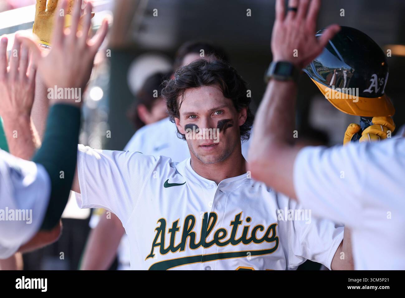 Athletics' Colby Thomas celebrates in the dugout after hitting a solo ...